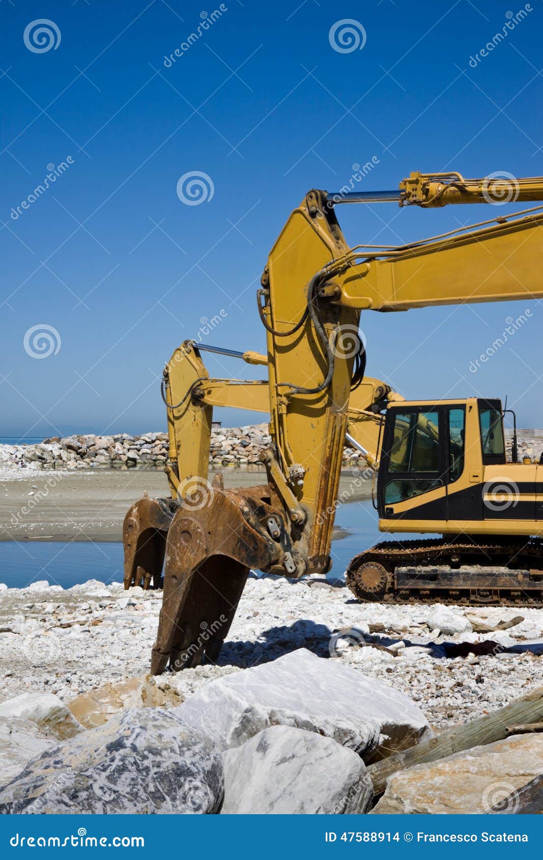Yellow Diggers on the Seashore Stock Photo - Image of people, overflow ...