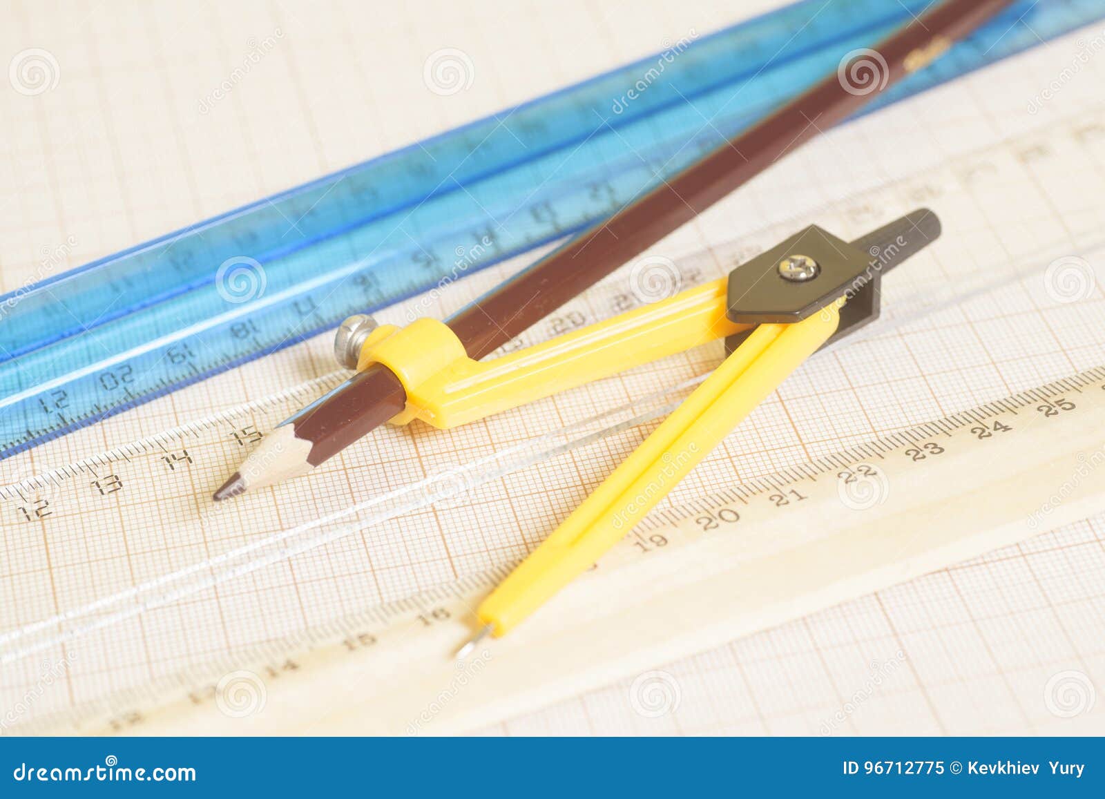Yellow Drawing Compass with Pensil and Rulers on Graph Paper.En Stock ...
