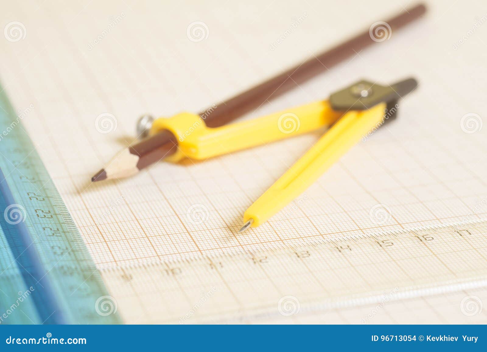 Yellow Drawing Compass with Pensil and Rulers on Graph Paper.En Stock ...