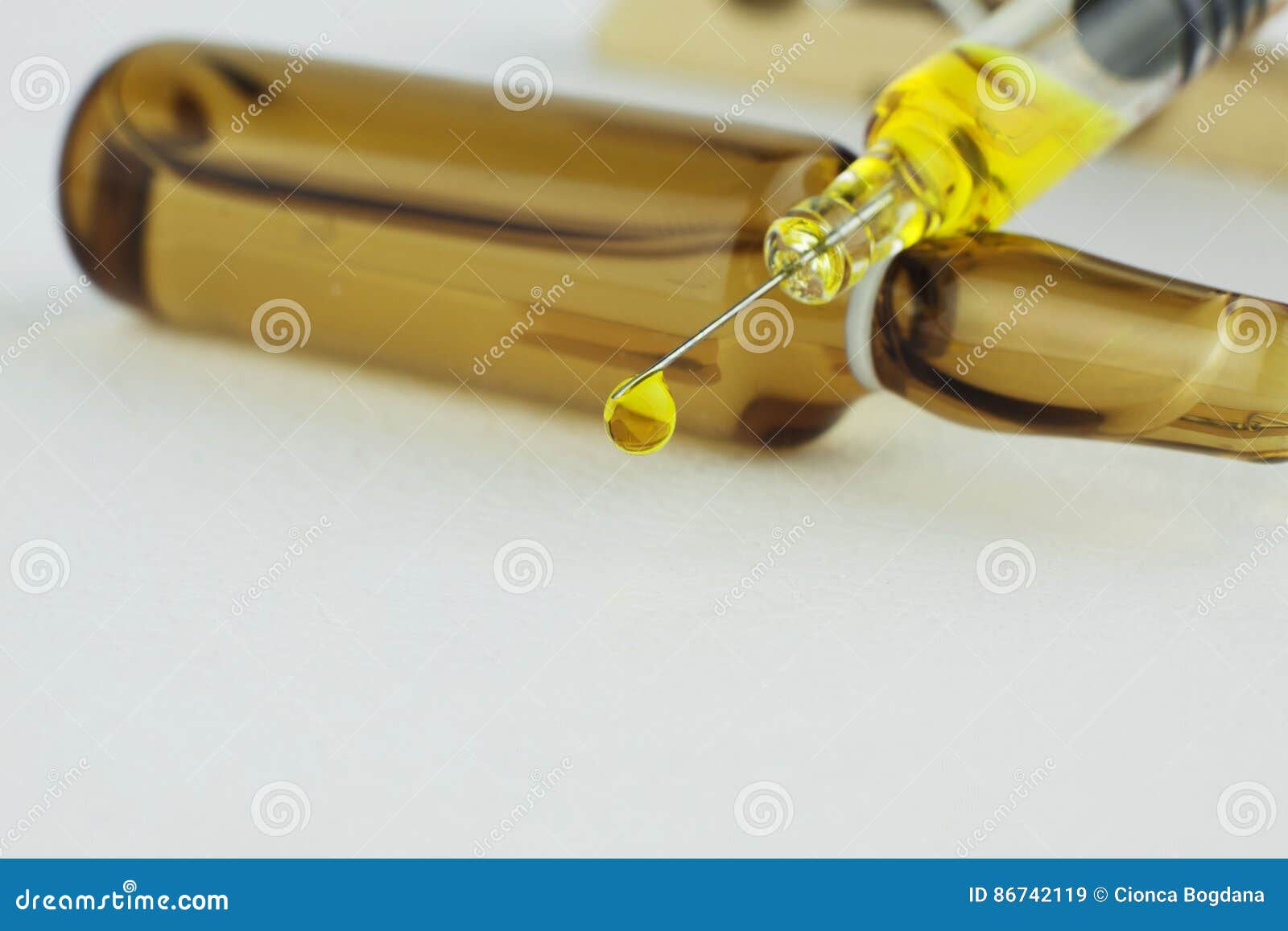 Yellow Drop Falling from the Top of the Syringe Stock Image - Image of ...