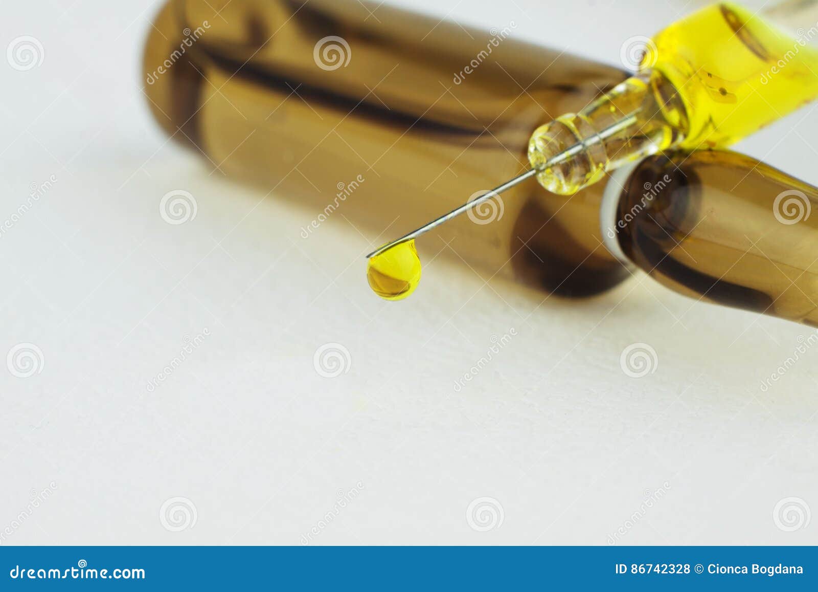 Yellow Drop Falling from the Top of the Syringe Stock Photo - Image of ...
