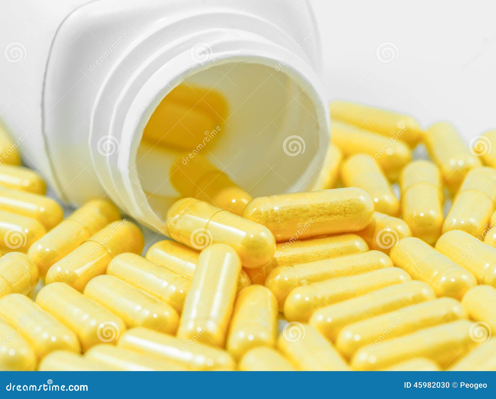Yellow Drug Capsules Spilled from Container Stock Photo - Image of ...
