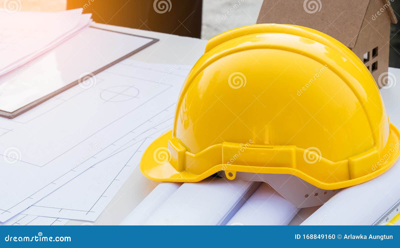 The Yellow Engineer Hat is on the Document and There is a House in the ...