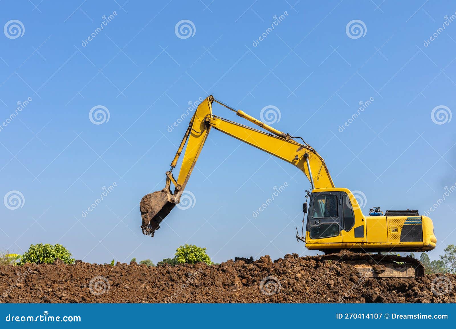Yellow Excavator Digging. Digger Machine Adjusting Ground Level in ...