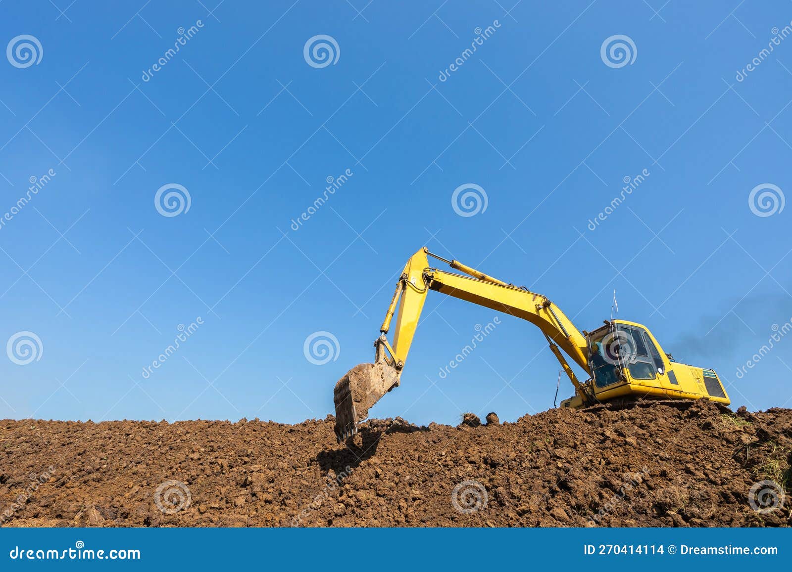 Yellow Excavator Digging. Digger Machine Adjusting Ground Level in ...