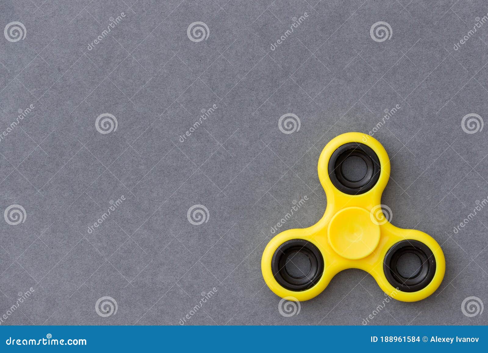 Yellow Fidget Spinner Device on Grey Background. Top View Stock Photo ...