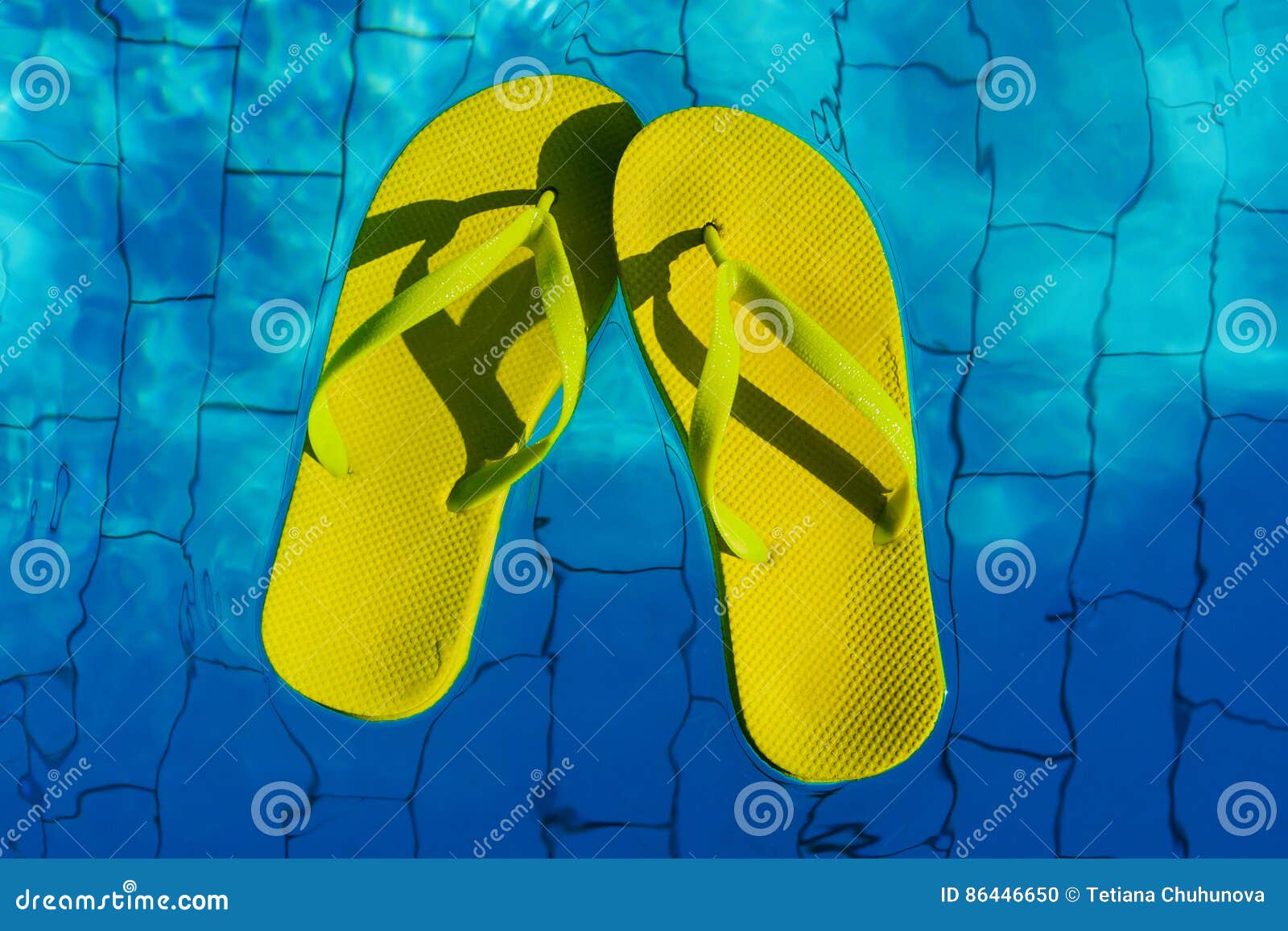 Yellow Flip-flops Floating in a Swimming Pool, a Top View Stock Photo ...