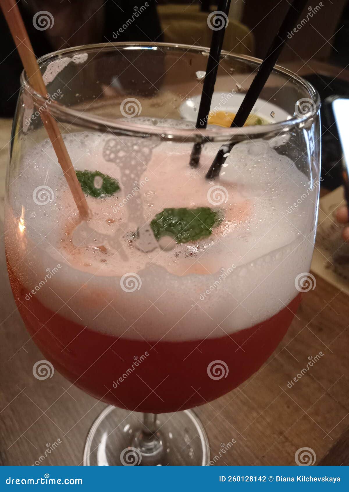 Red cocktail on the table stock photo. Image of plant - 260128142