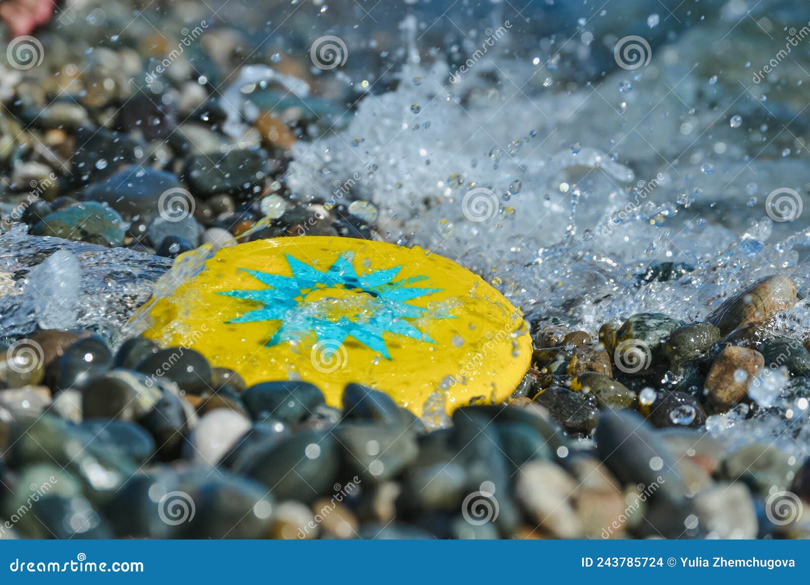 Yellow Frisbee Triboard on the Stone Beach Stock Photo - Image of ...