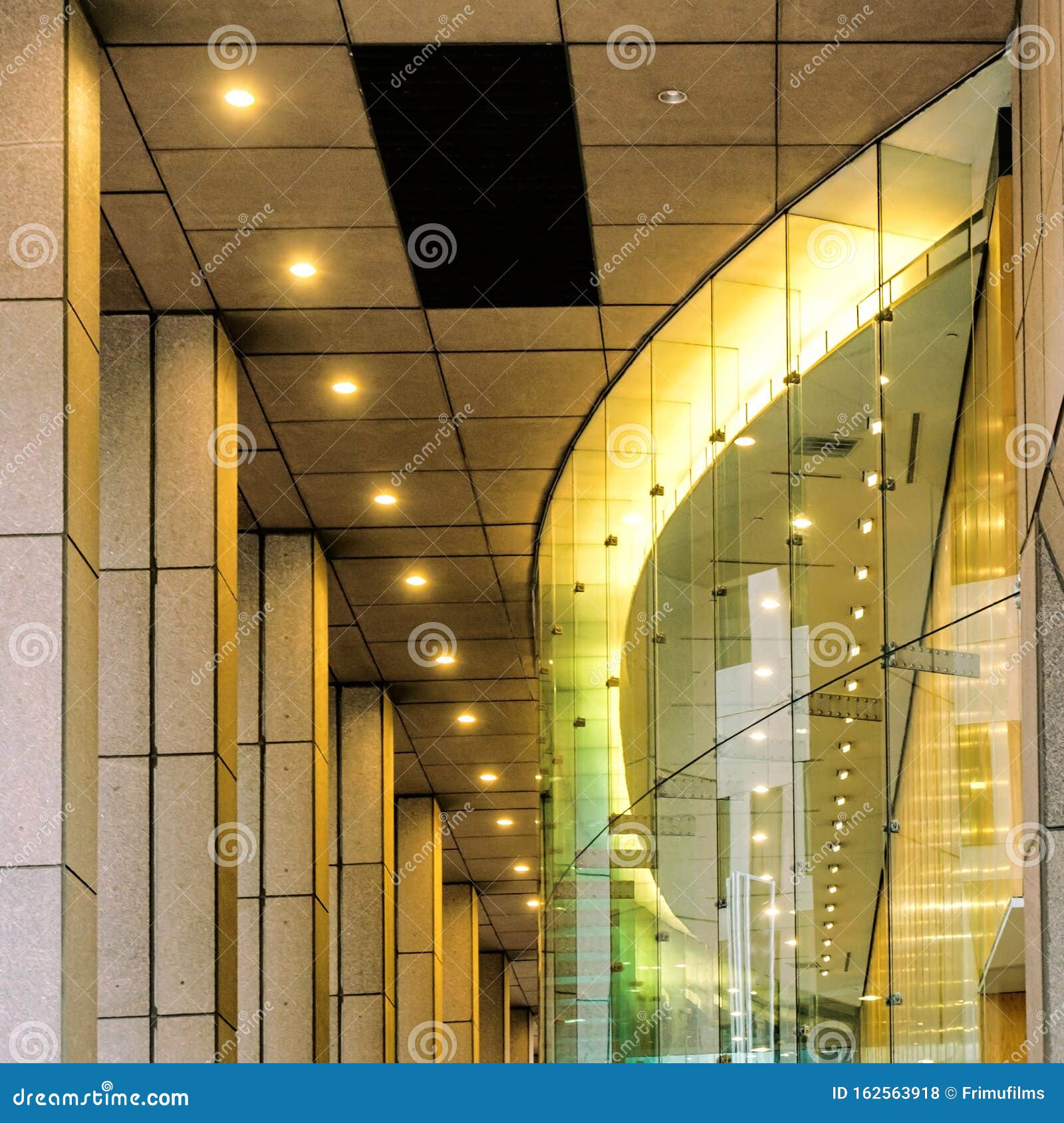 Yellow Glass Building with Lights and Columns Stock Photo - Image of ...