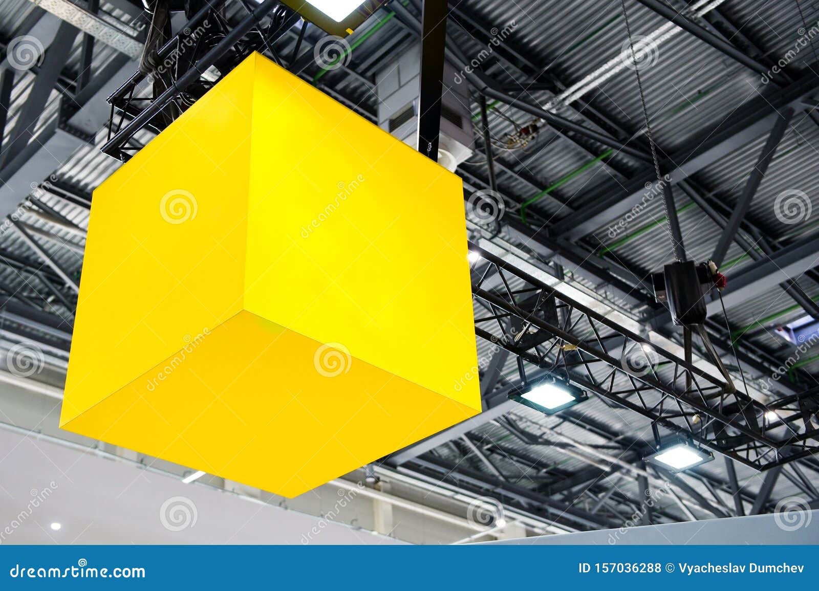 A Yellow Glowing Cube Hangs Under the Ceiling in a Hangar Stock Photo ...