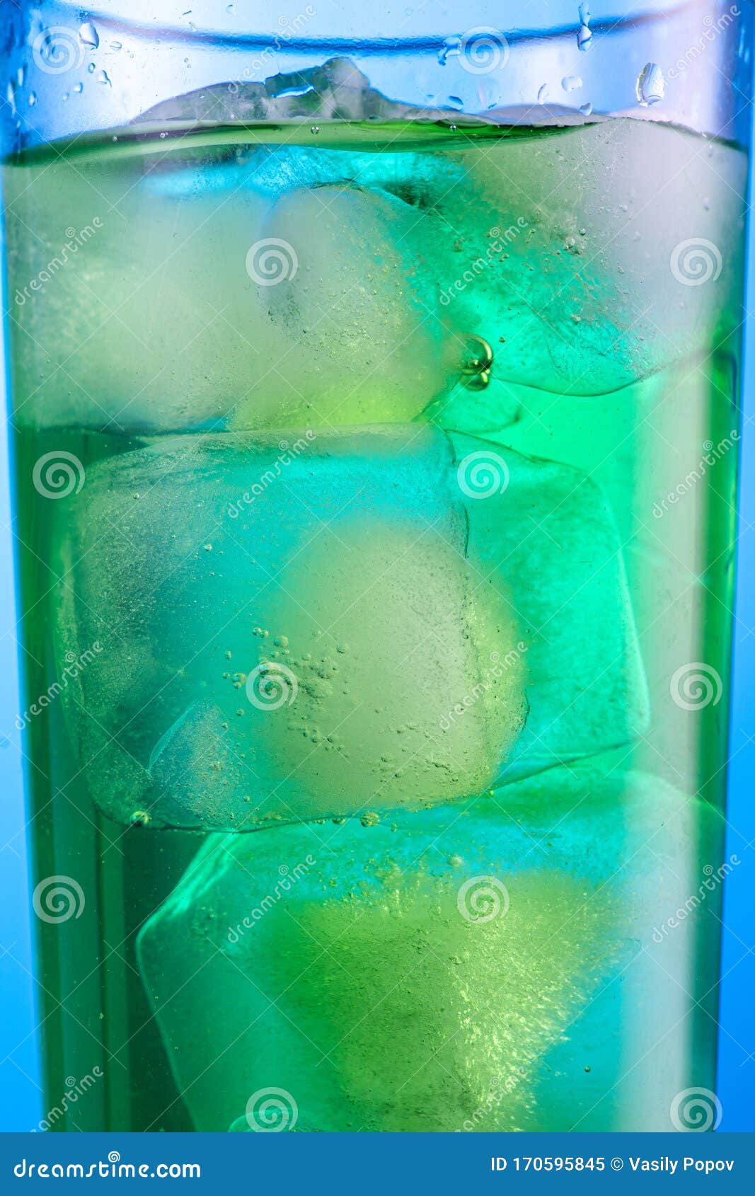 Yellow or Green Carbonated Lemonade in a Glass with Ice, Flow and ...