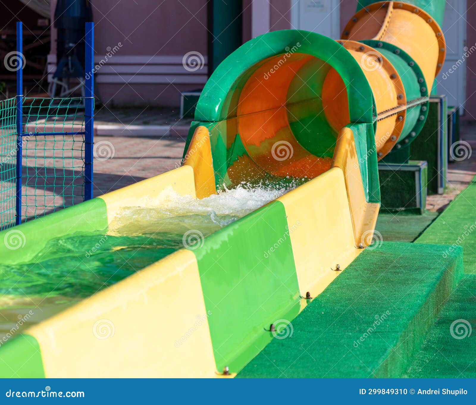 Yellow-green Slide in the Pool of the Water Park Stock Photo - Image of ...