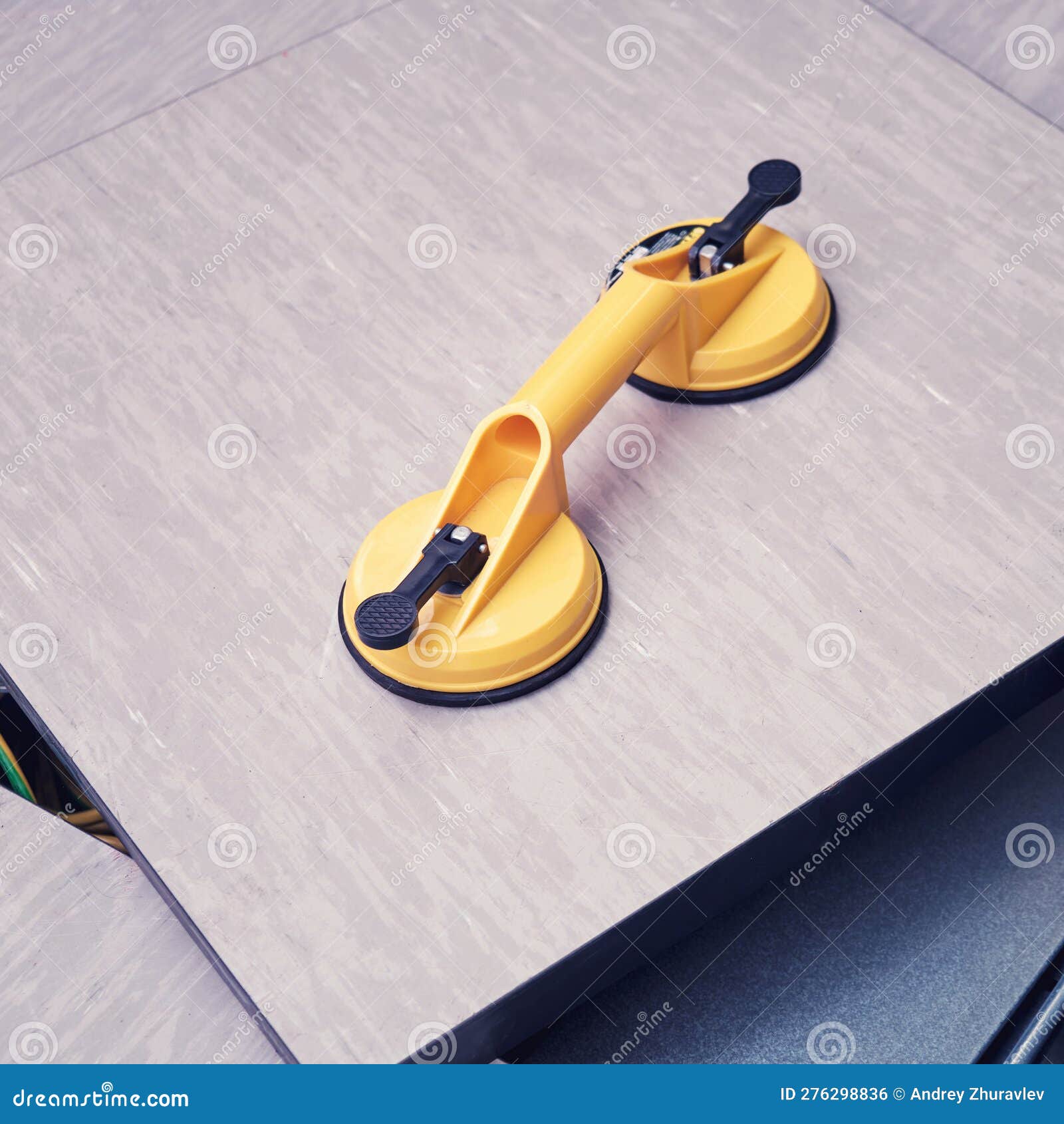 Yellow Handheld Device with Vacuum Suction Cups for Lifting Floor ...