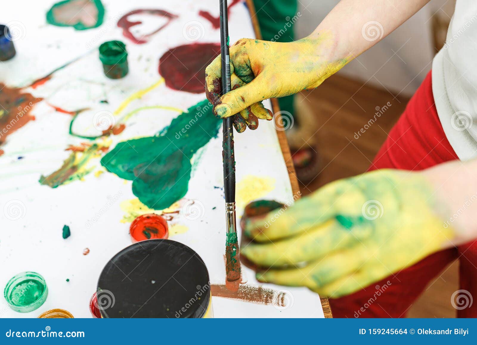 Yellow Hands in Paints on Light Table Painted in Different Colors Stock ...