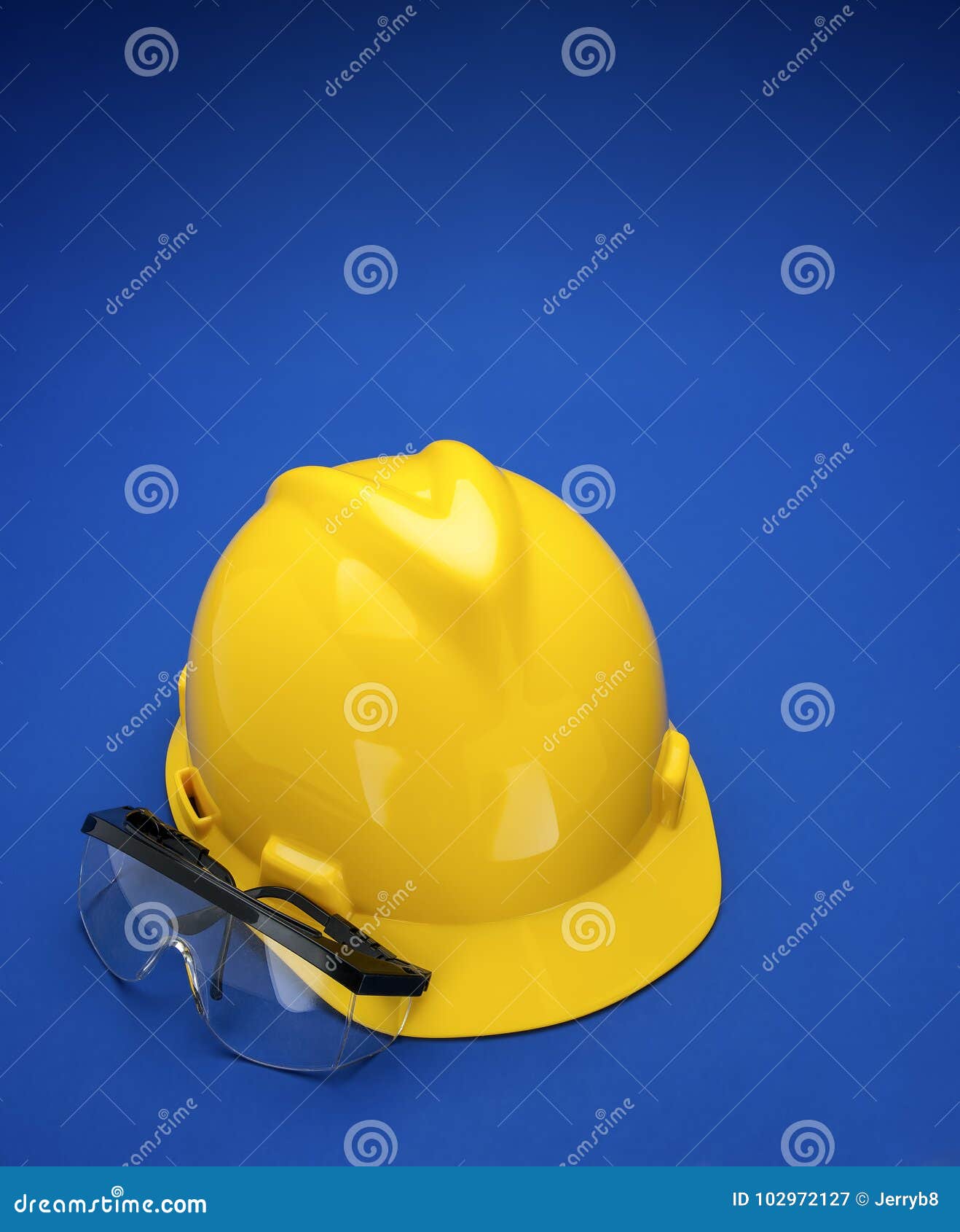 Yellow Hard Hat on Blue Back Drop Stock Image - Image of blue ...