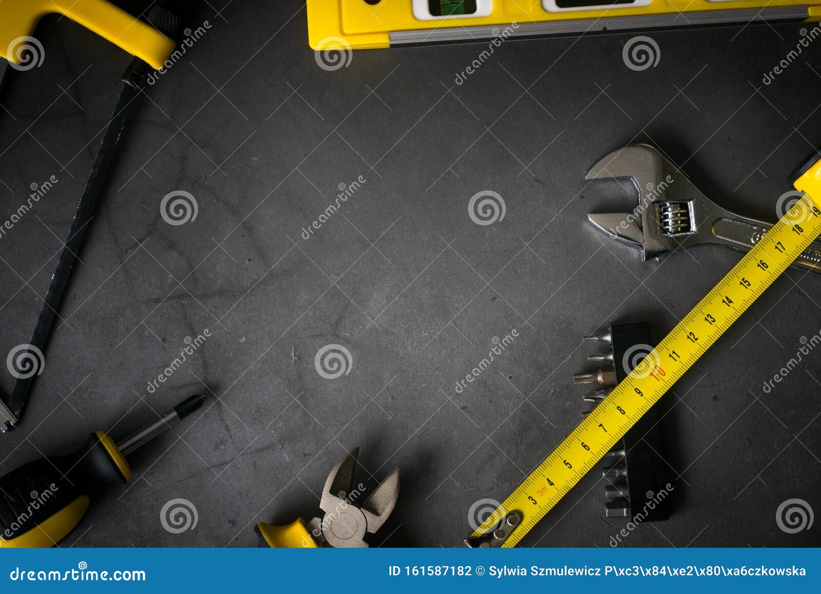 Yellow Hardware Tools on Black Concrete Background with Some Space for ...