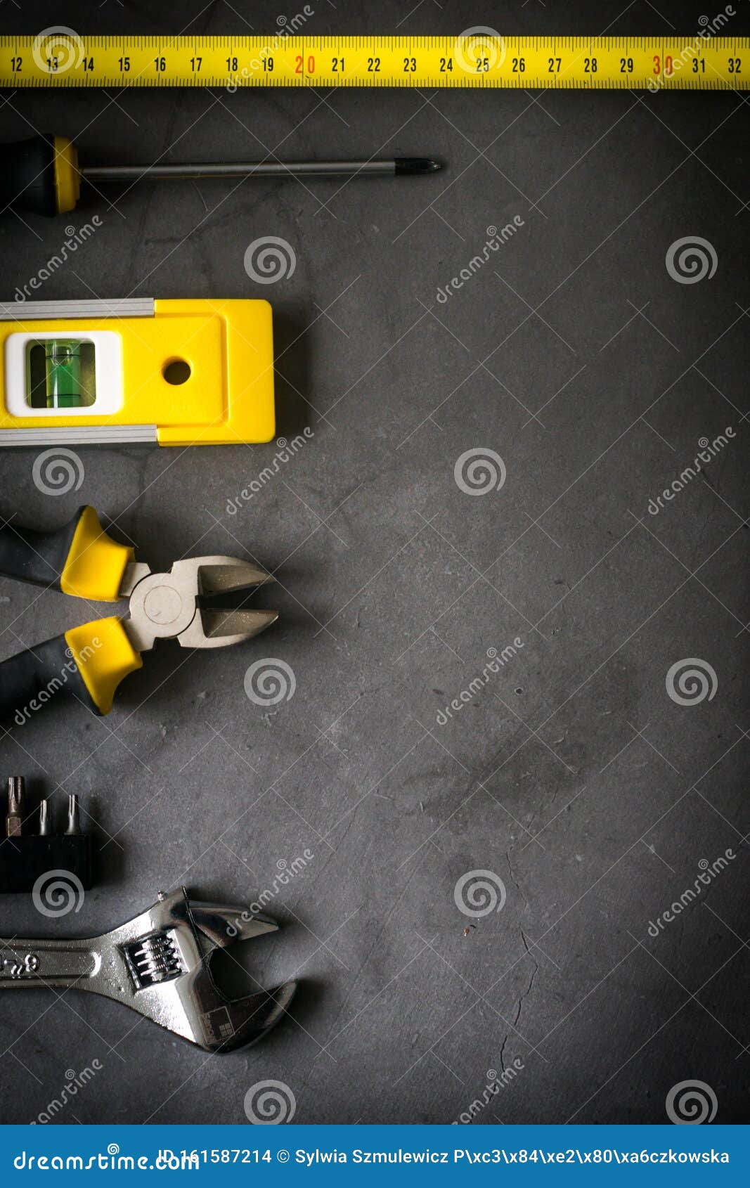 Yellow Hardware Tools on Black Concrete Background with Some Space for ...