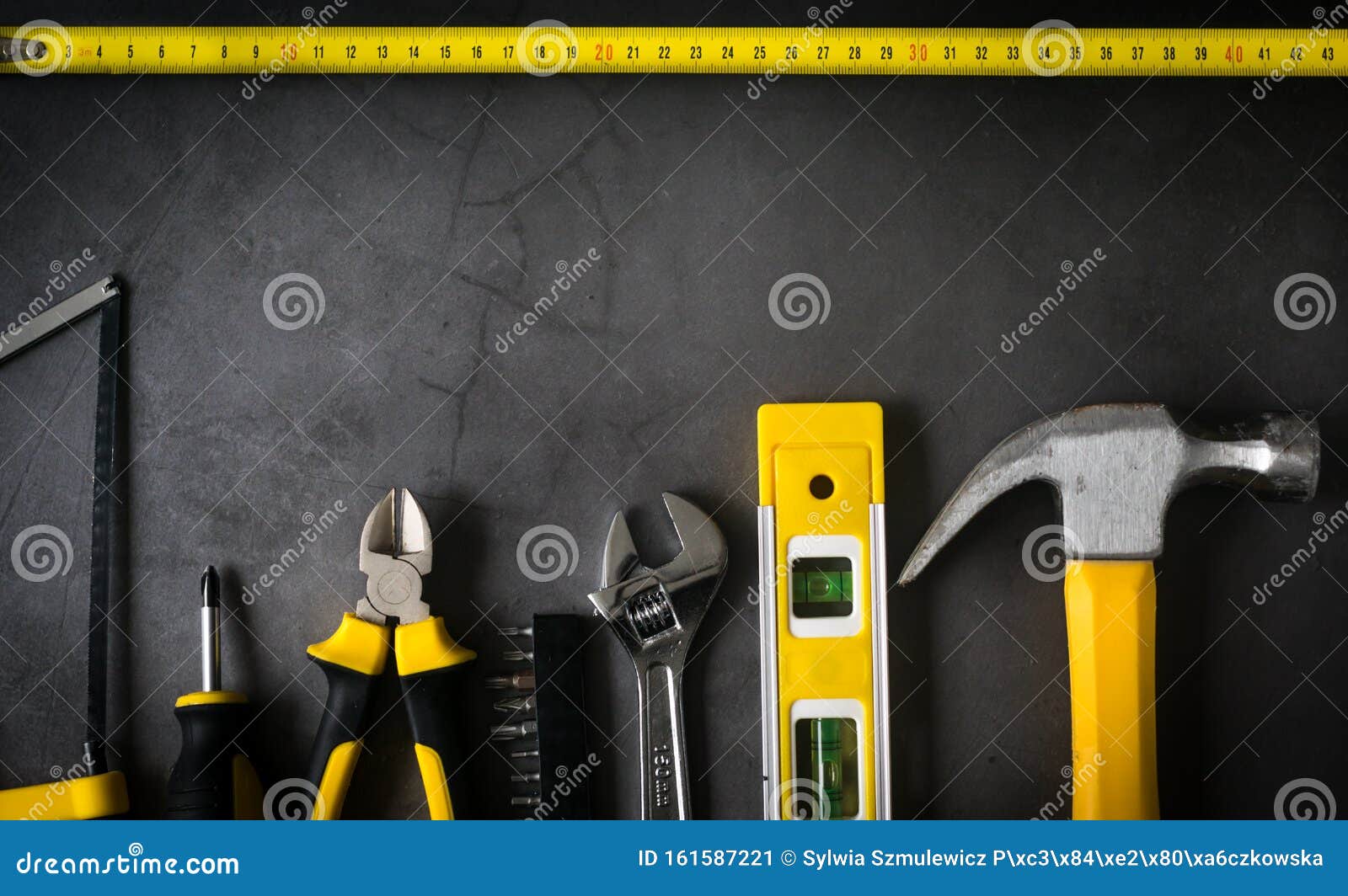 Yellow Hardware Tools on Black Concrete Background with Some Space for ...