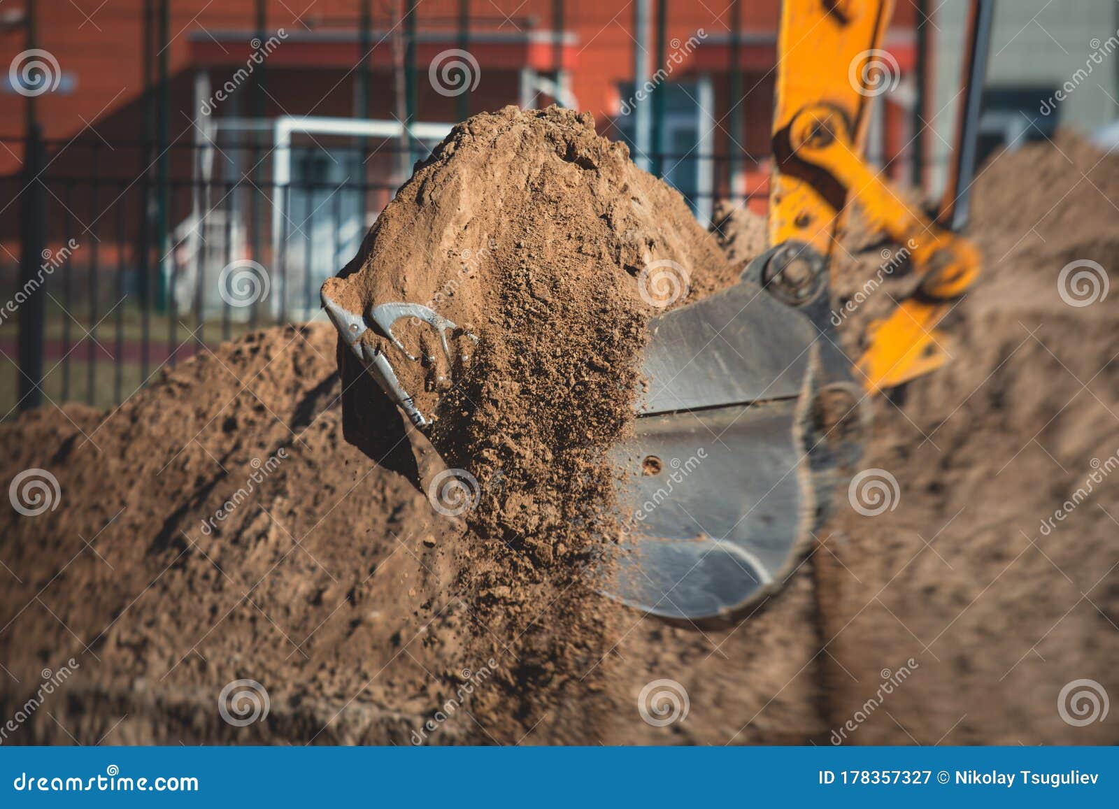 Yellow Heavy Excavator Excavating Sand and Working during Road Works ...