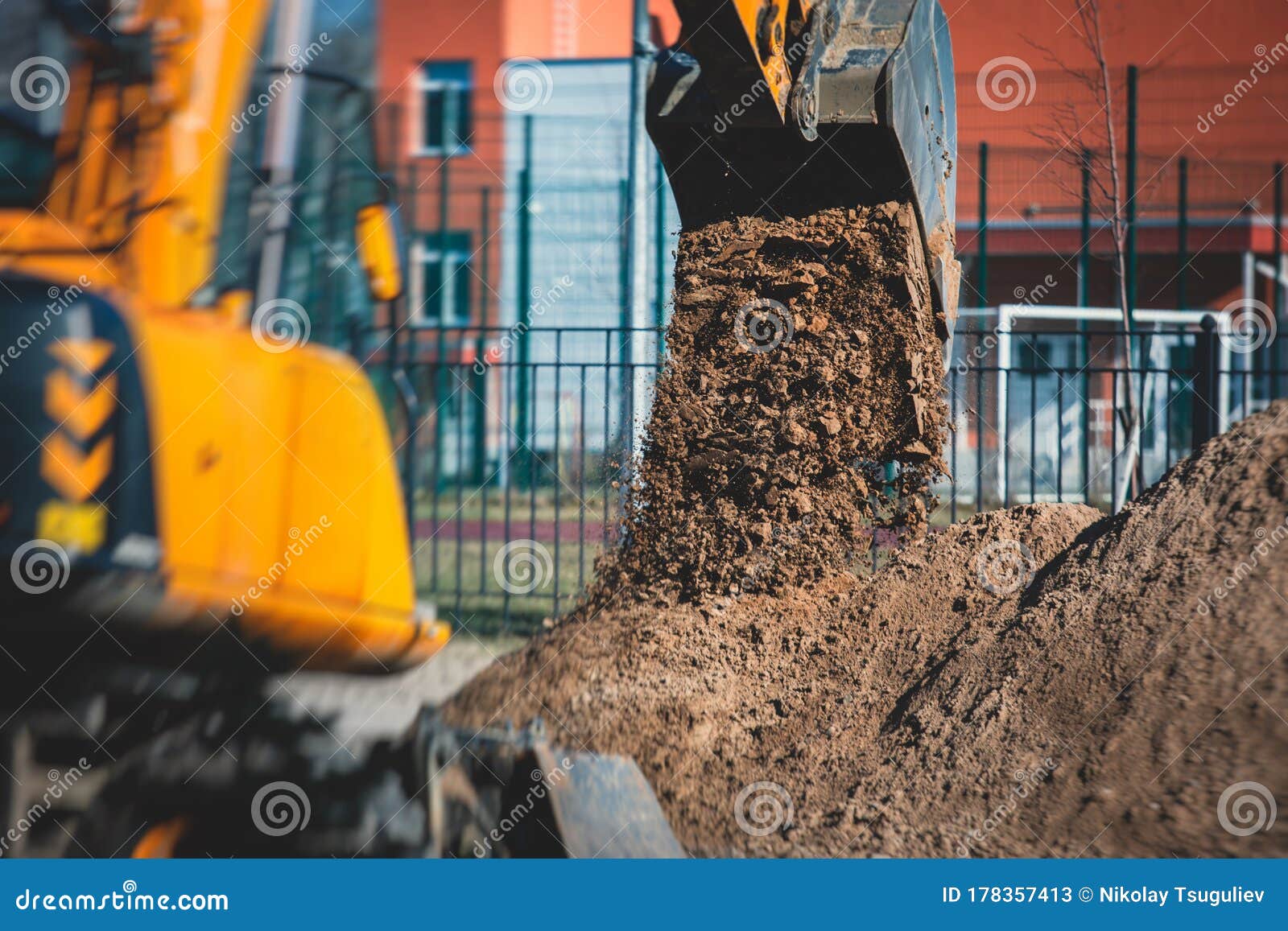 Yellow Heavy Excavator Excavating Sand and Working during Road Works ...