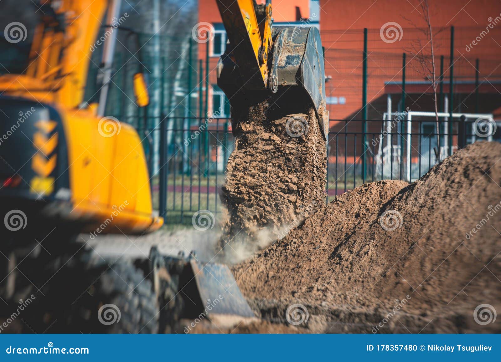 Yellow Heavy Excavator Excavating Sand and Working during Road Works ...