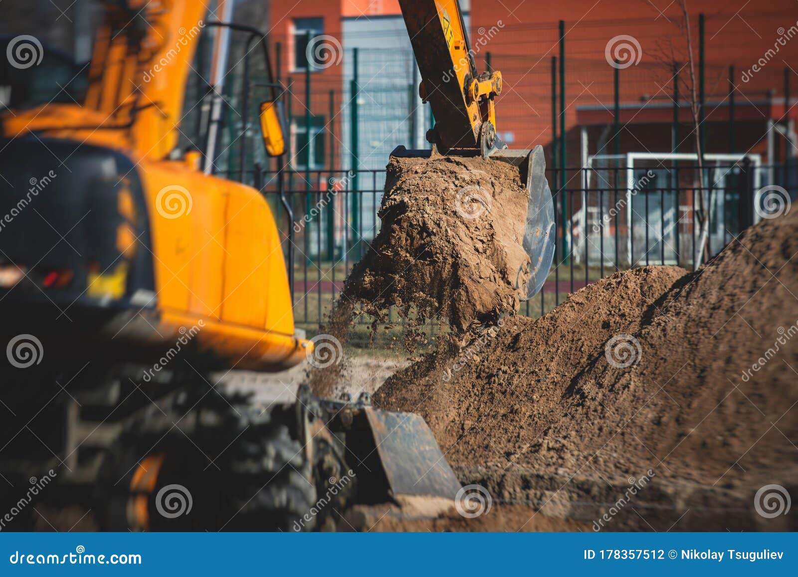 Yellow Heavy Excavator Excavating Sand and Working during Road Works ...