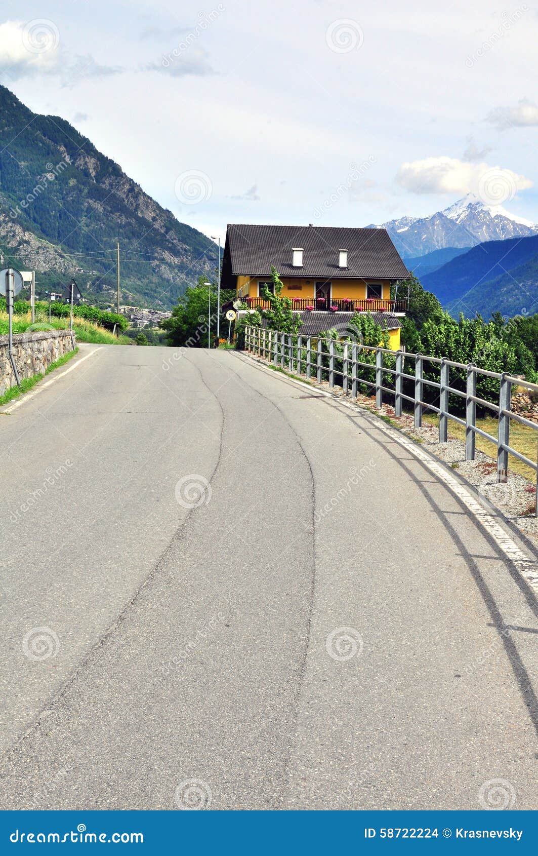 Yellow house in Alps stock photo. Image of highway, road - 58722224