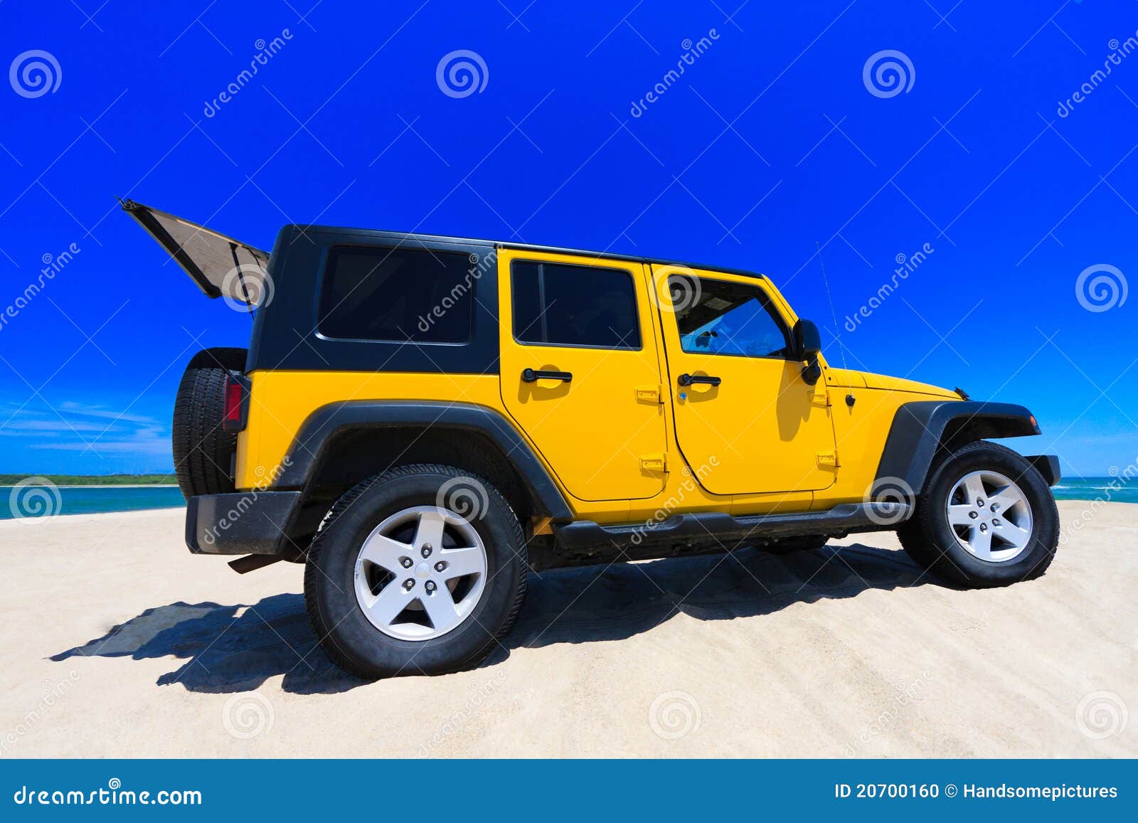 Yellow Jeep on the Beach stock photo. Image of white - 20700160