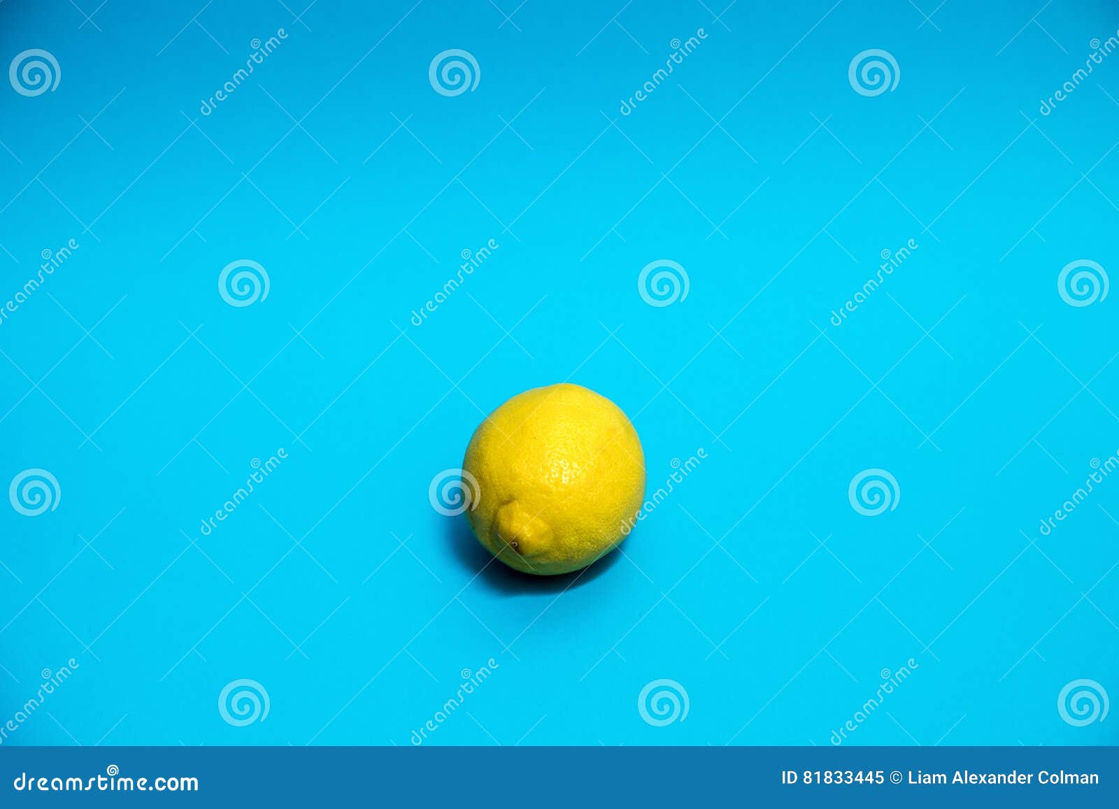 Yellow Lemon Against a Blue Background Stock Image - Image of ...
