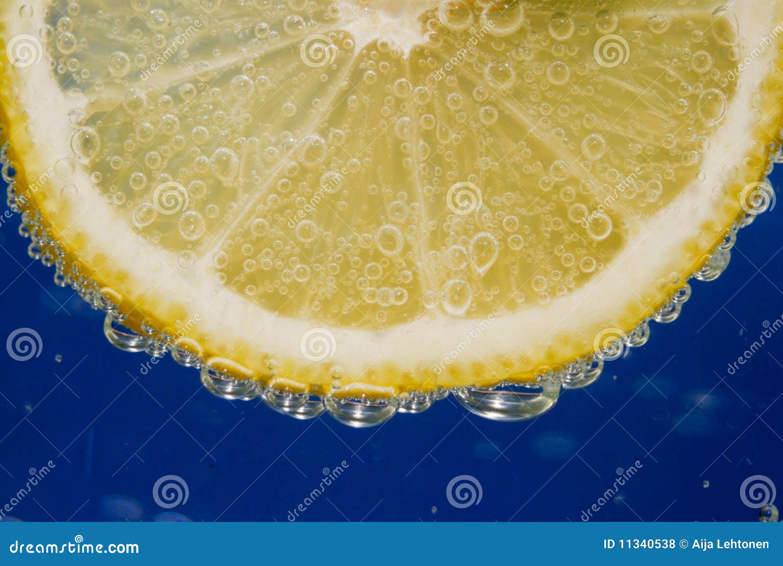 Yellow Lemon in Blue Water stock photo. Image of yellow - 11340538