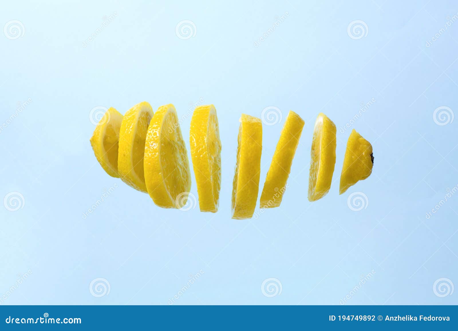 Yellow Lemon In The Section. Cut Into Small Slices On A Blue Background ...