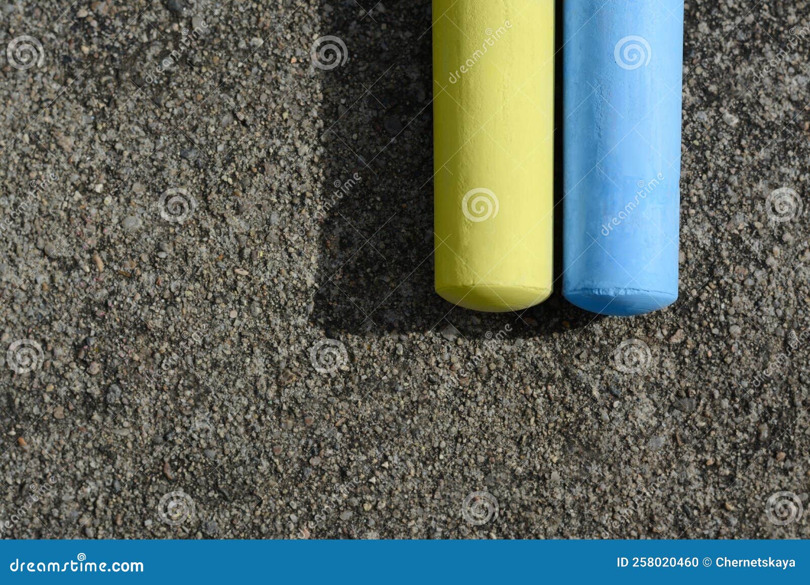 Yellow and Light Blue Chalk Sticks on Asphalt, Flat Lay. Space for Text ...