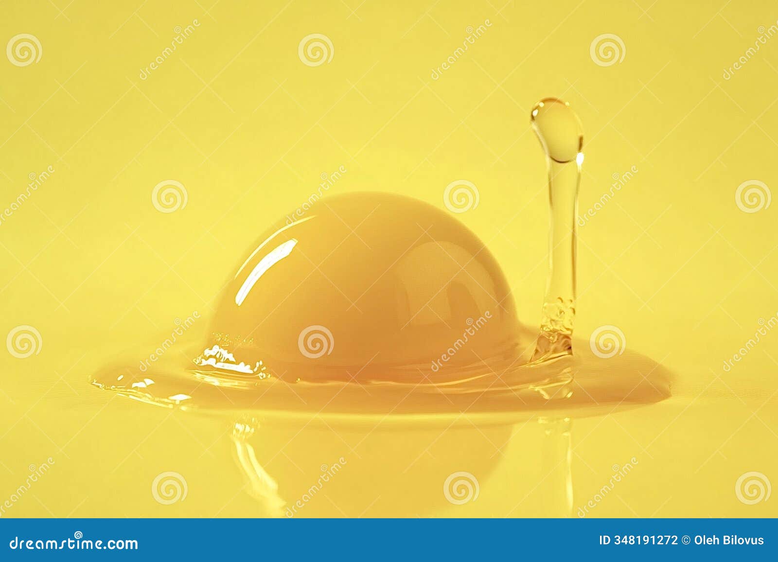 Yellow Liquid Splashing into a Dome on Yellow Background Stock Photo ...
