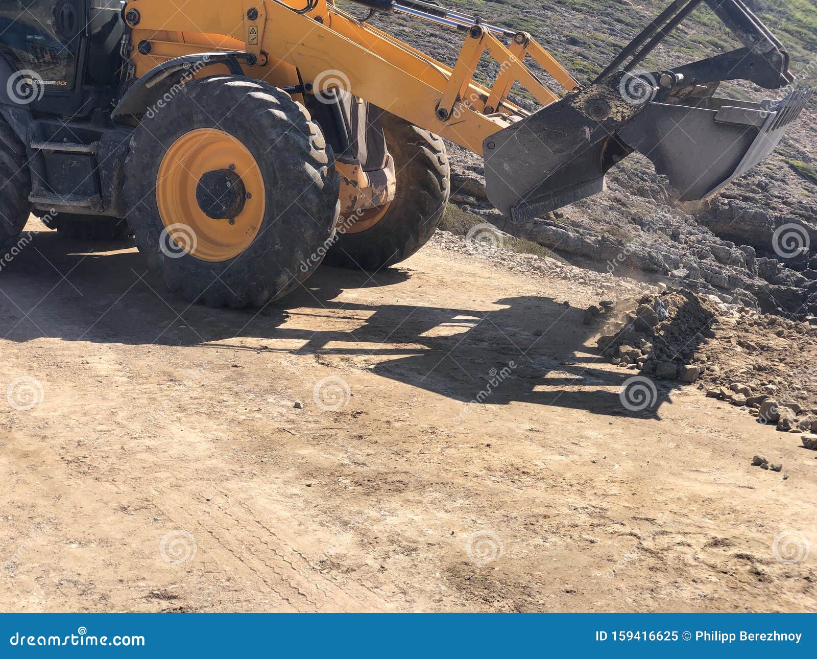 Yellow Loader Backhoe is Planning a Road Surface during Road ...