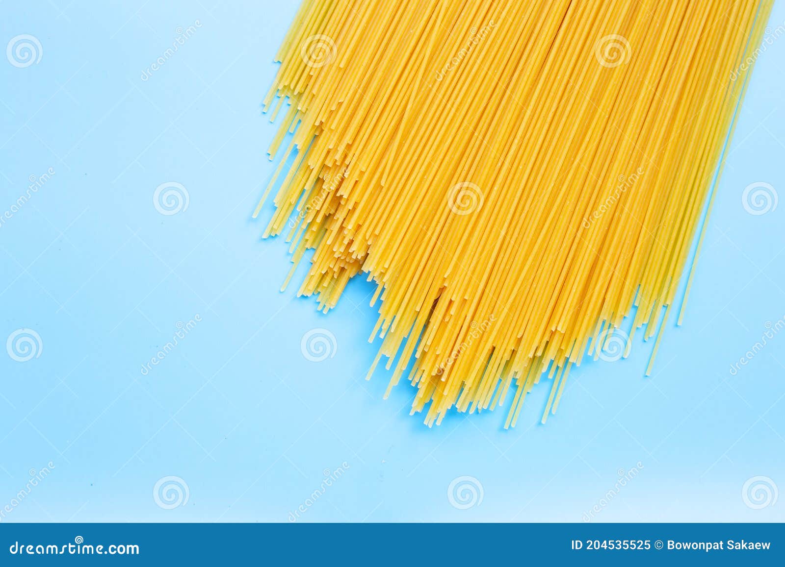 Yellow Long Spaghetti on Blue Background. Copy Space Stock Image ...