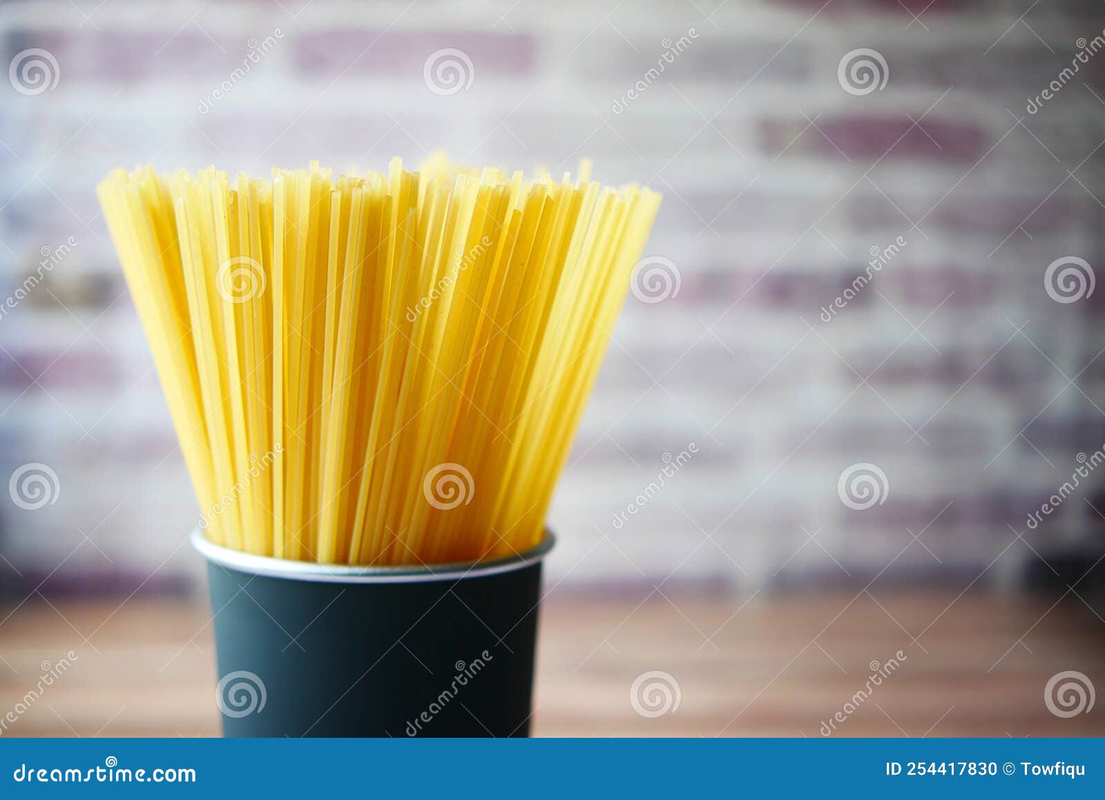 Yellow Long Spaghetti in a Container on Table Stock Photo - Image of ...