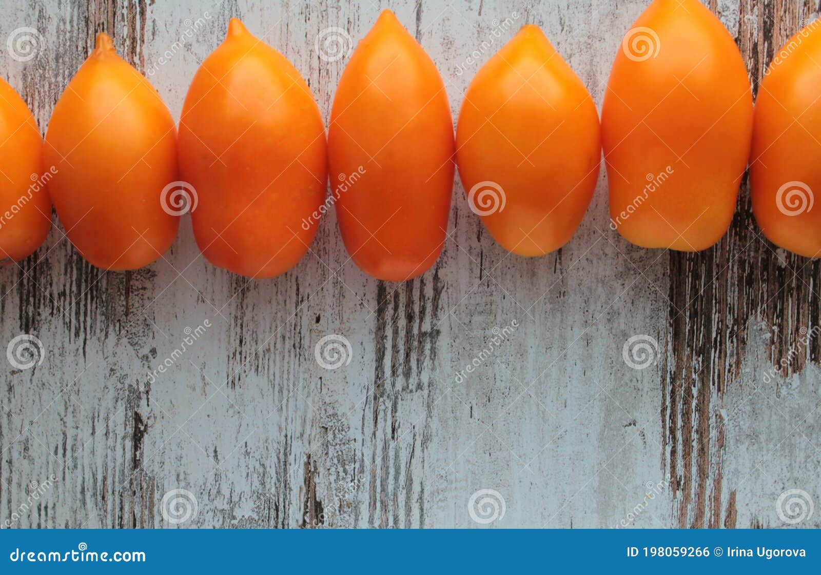 Yellow Long Tomatoes on a Wooden Surface. Stock Photo - Image of juicy ...