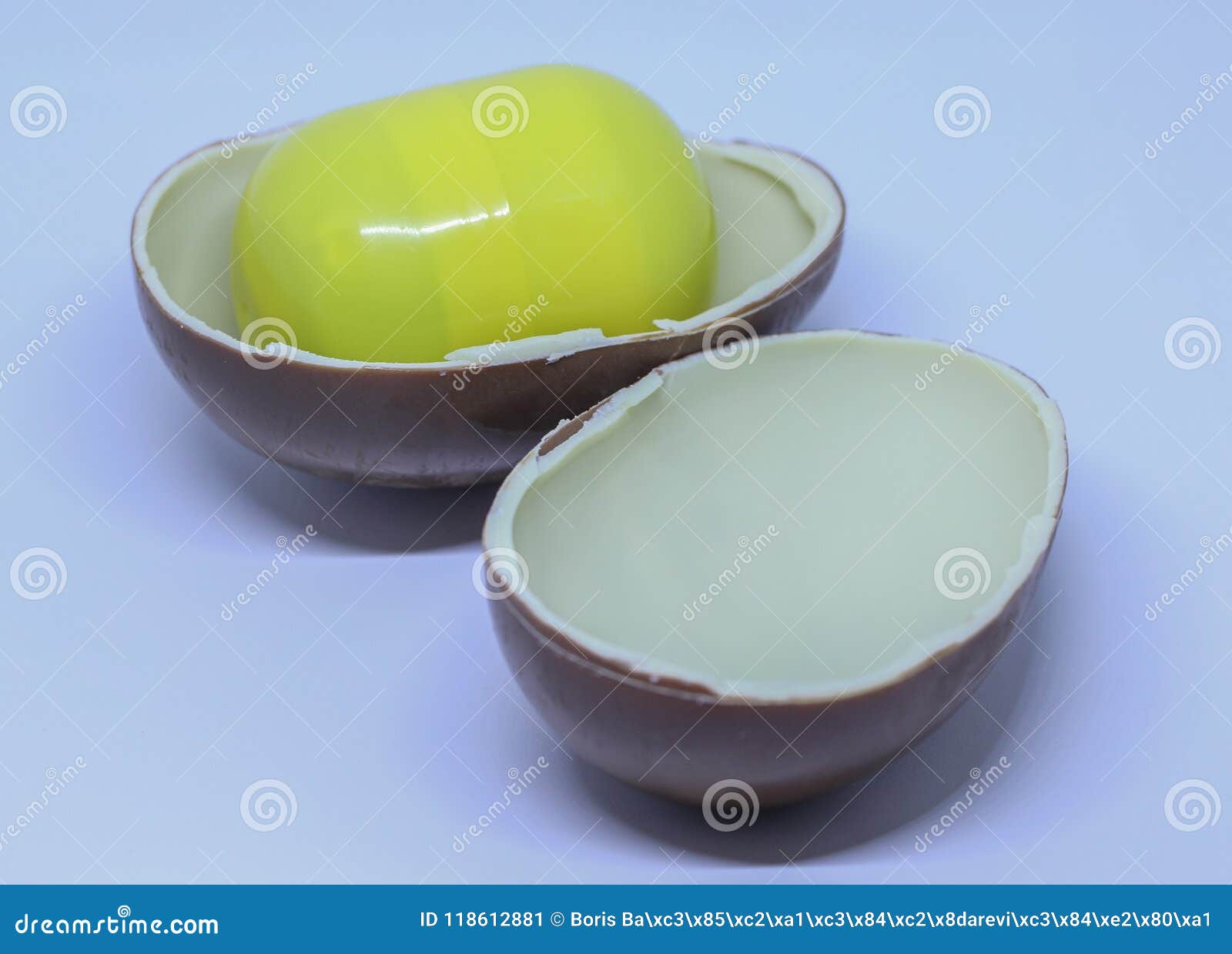 Yellow Maxi Kinder Egg Toy Box and Two Side of Chocolate Shells. Stock ...