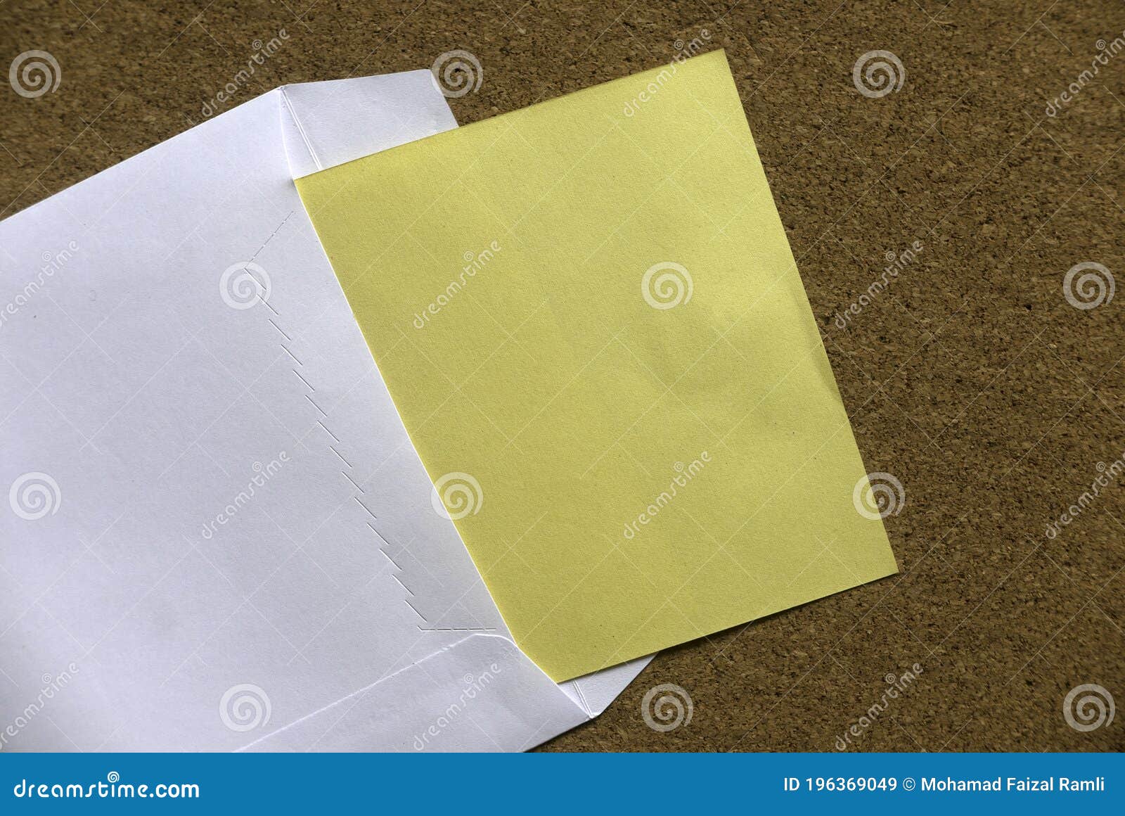 A Yellow Memo Note and Envelope on Notice Cork Board. Copy Space for ...