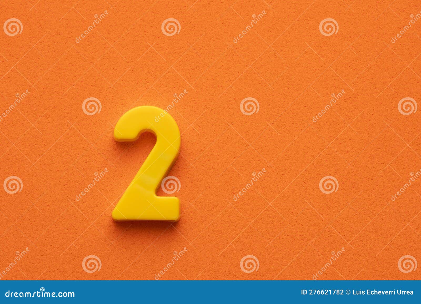 Yellow Number 2 - Plastic Piece on Orange Foamy Background Stock Photo ...