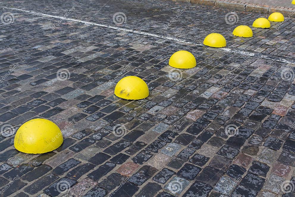 Yellow Obstacles on the Pavement Stock Photo - Image of barricade ...