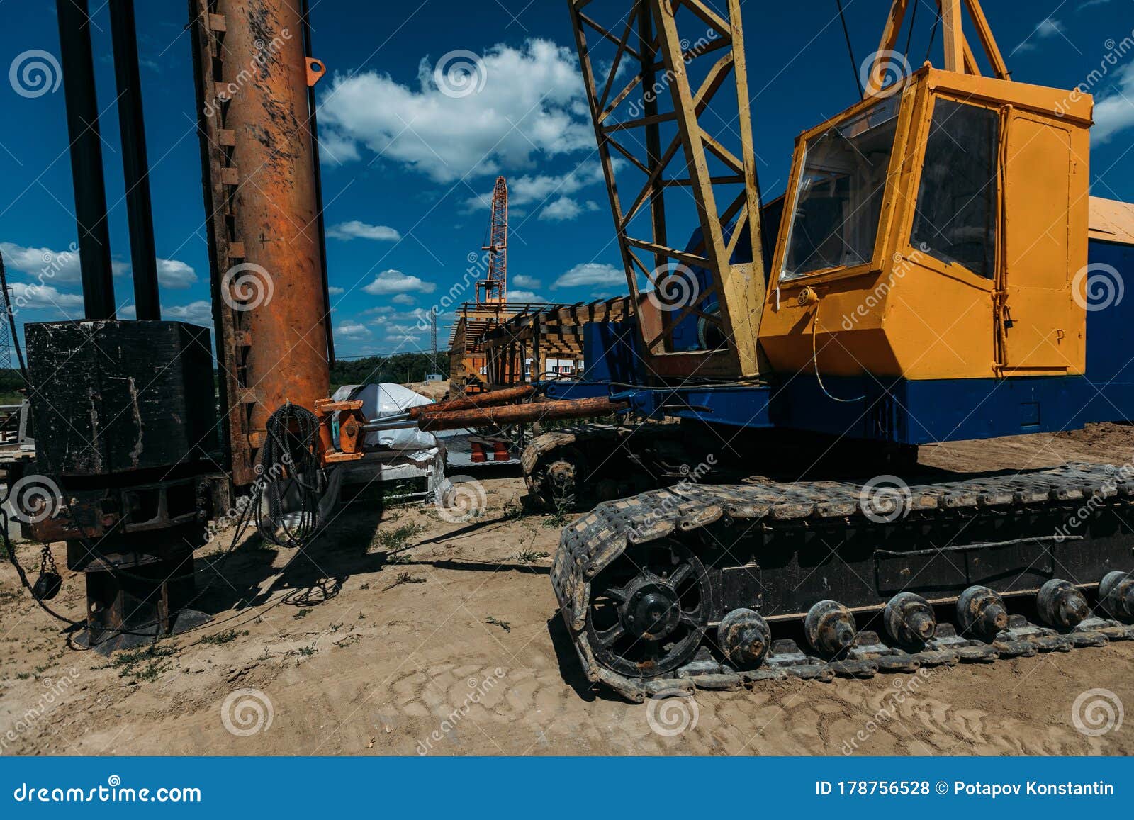 Yellow Pile Driver with Large Caterpillars on a Sunny Day Stock Photo ...