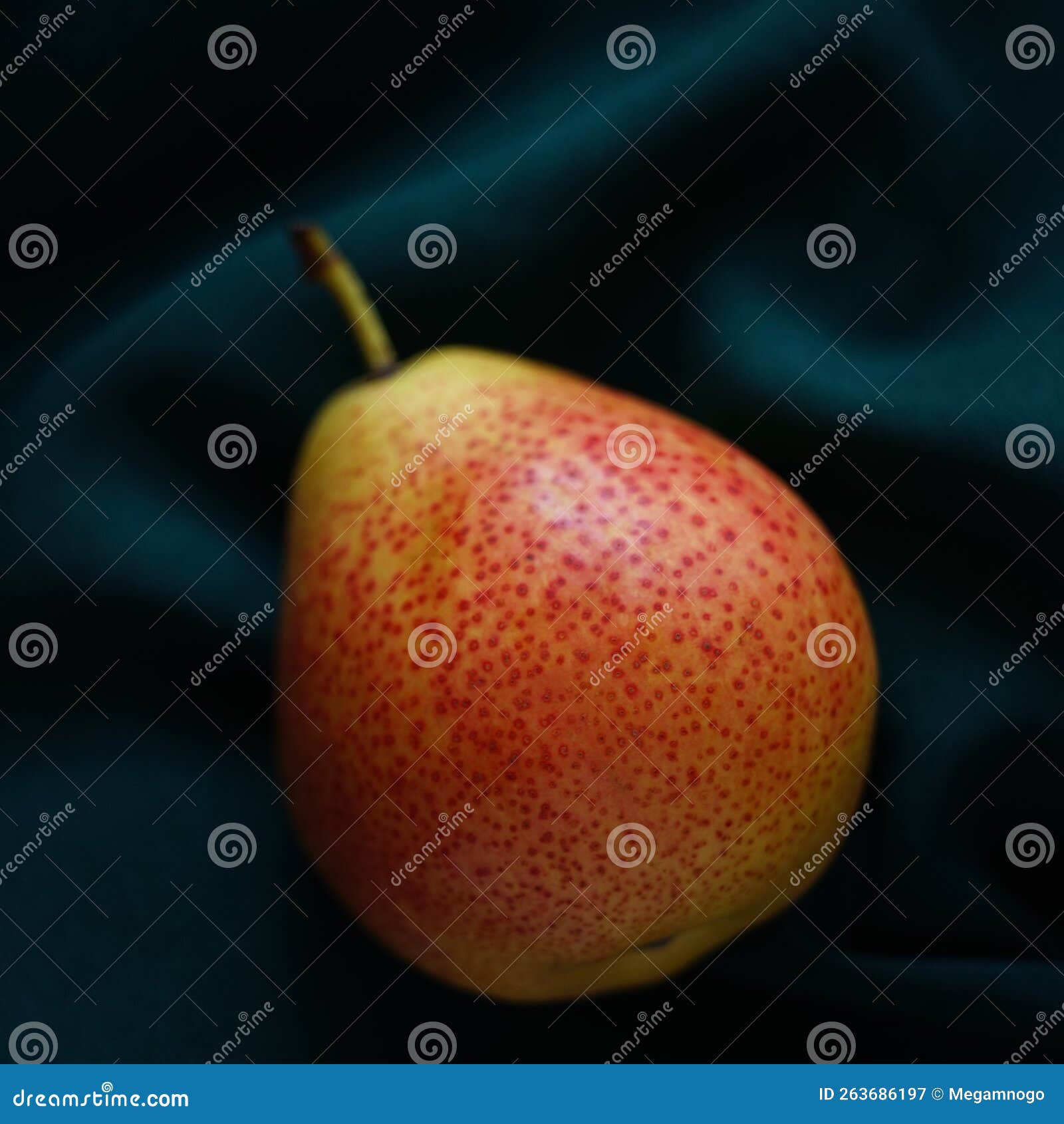 Yellow Orange Pear on a Dark Green Table Stock Image - Image of closeup ...