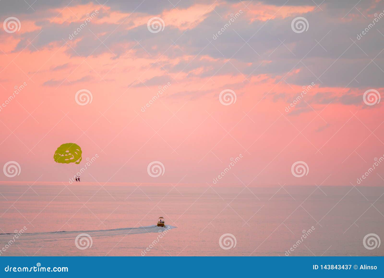 Yellow Parasail Wing Pulled by a Boat on Beautiful Pink Sunset Stock ...