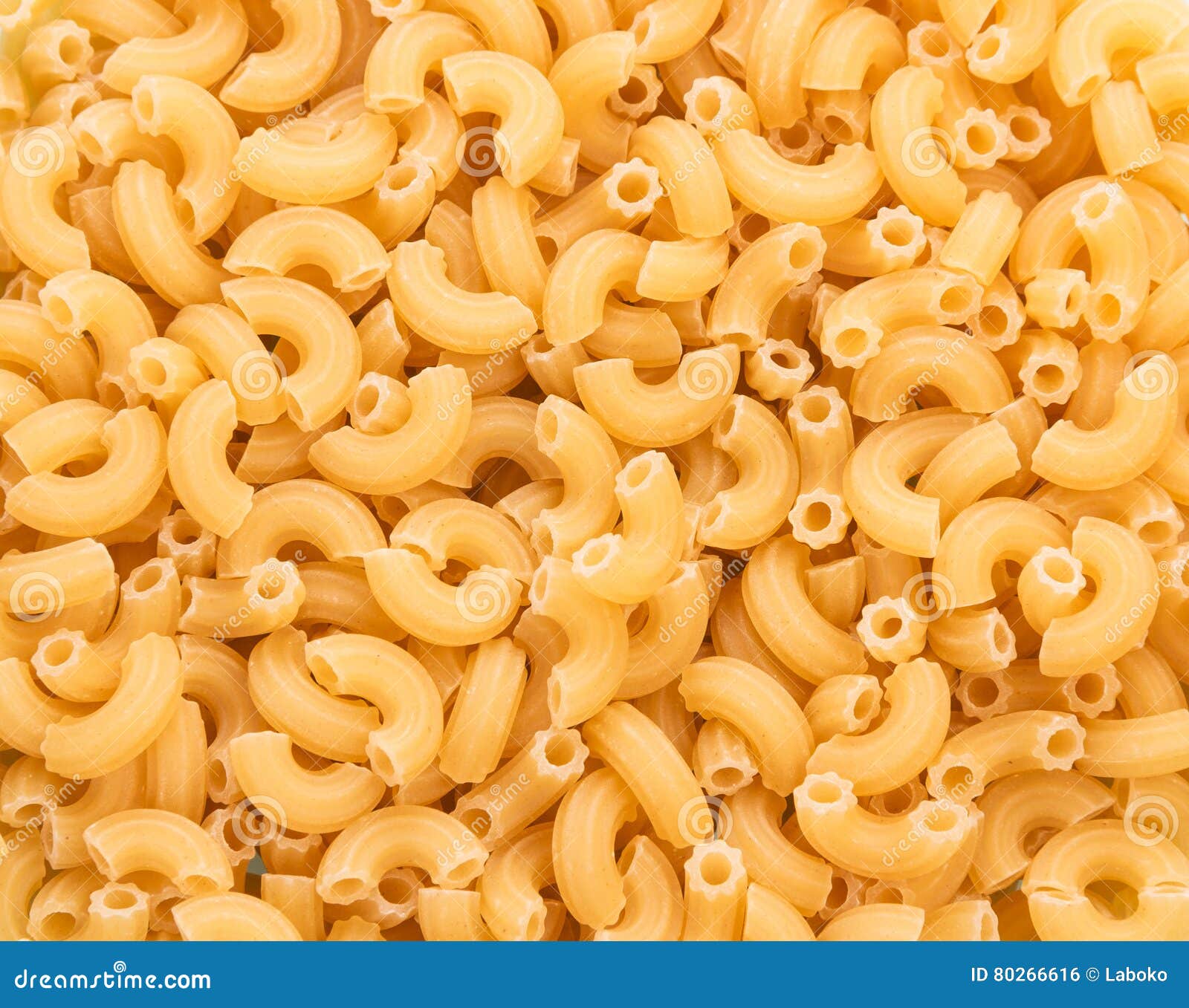 Yellow Pasta in Form of Curved Tubes Closeup. Texture. Stock Photo ...