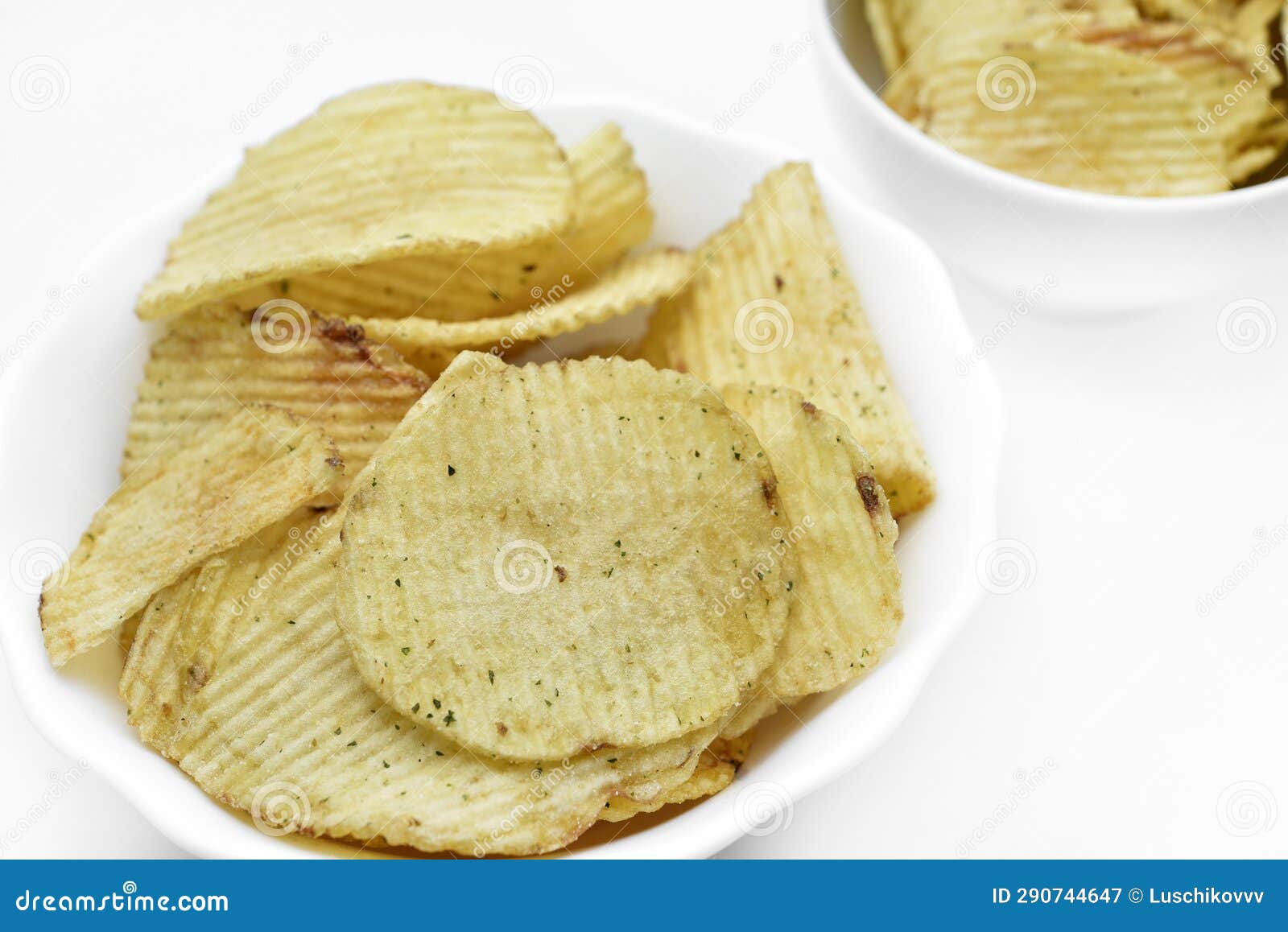 Yellow Pieces of Fried Potatoes in a Plate. Salted Chips on a White ...