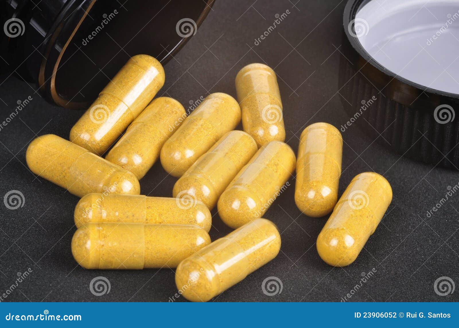 Yellow Pills stock photo. Image of capsule, black, herbal - 23906052
