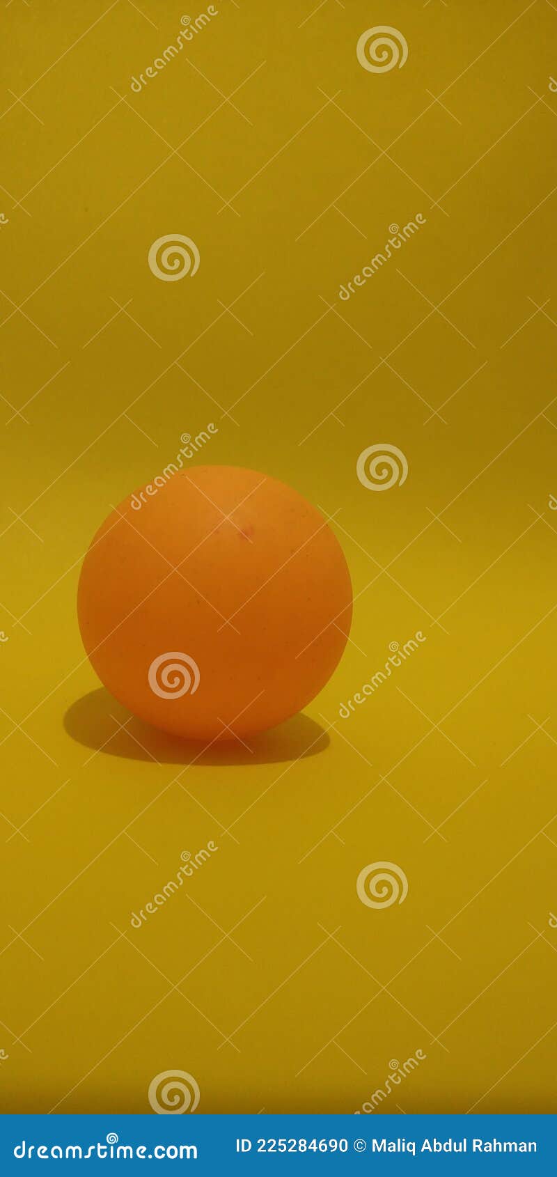A Yellow Ping Pong Ball with a Striking Yellow Stock Photo - Image of ...