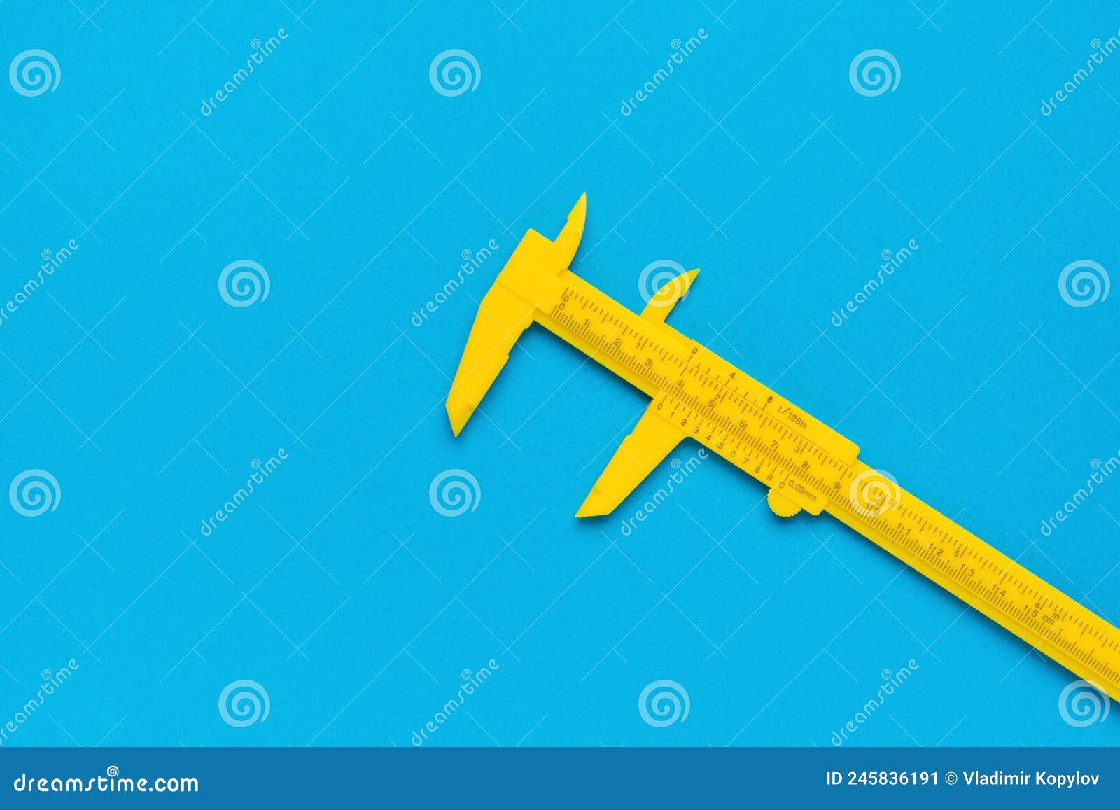 A Yellow Plastic Caliper on a Blue Background Stock Image - Image of ...